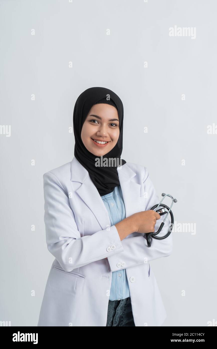 attractive muslim female doctor with white coat smiling Stock Photo - Alamy