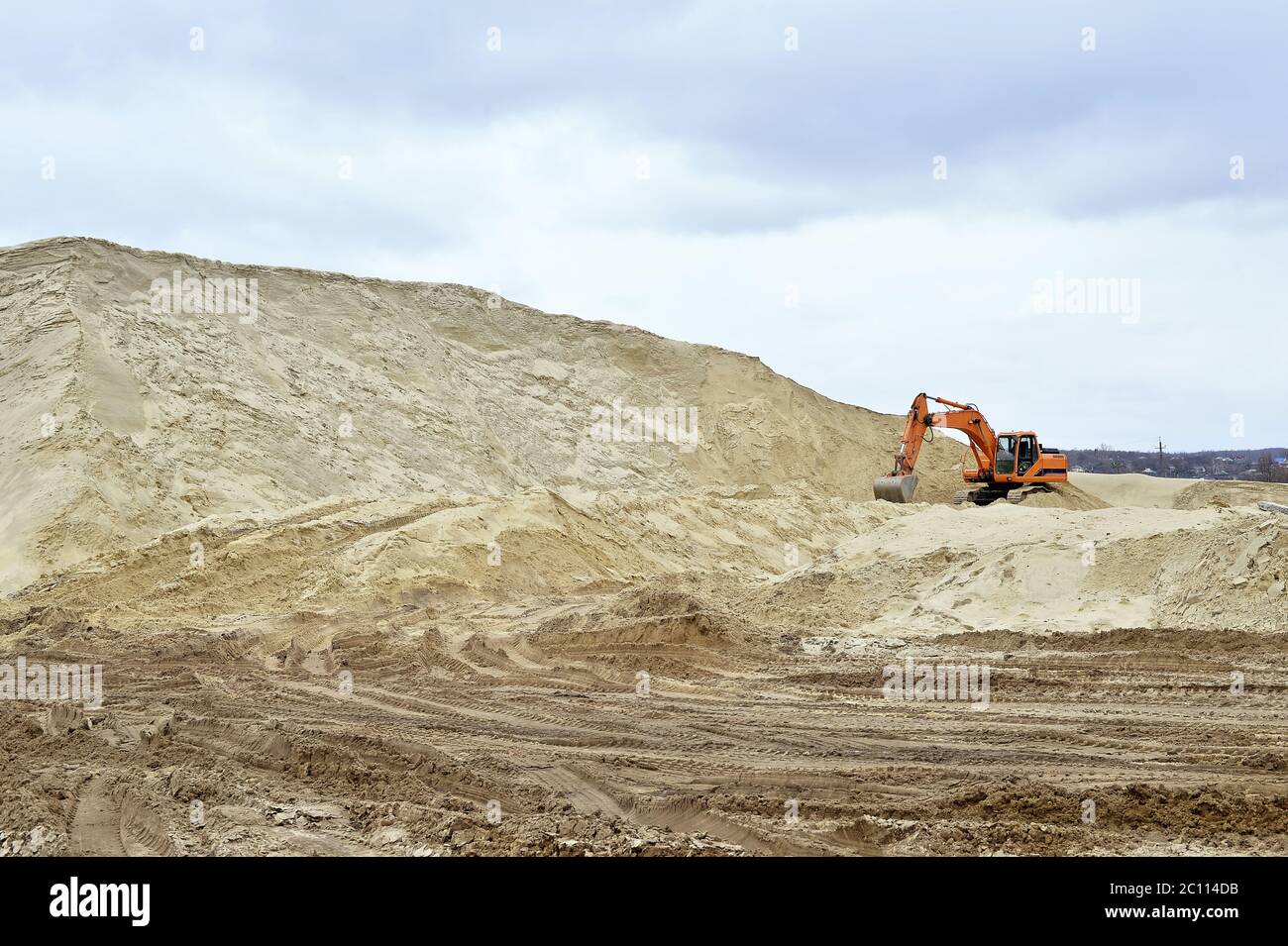 Working digger in a quarry produces sand Stock Photo - Alamy