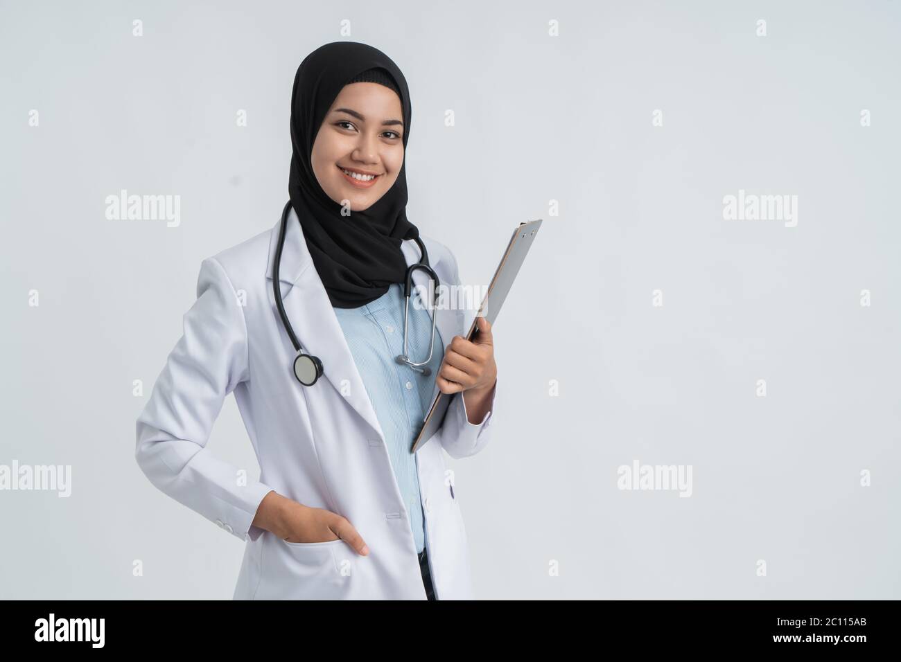 attractive muslim female doctor with white coat smiling Stock Photo - Alamy
