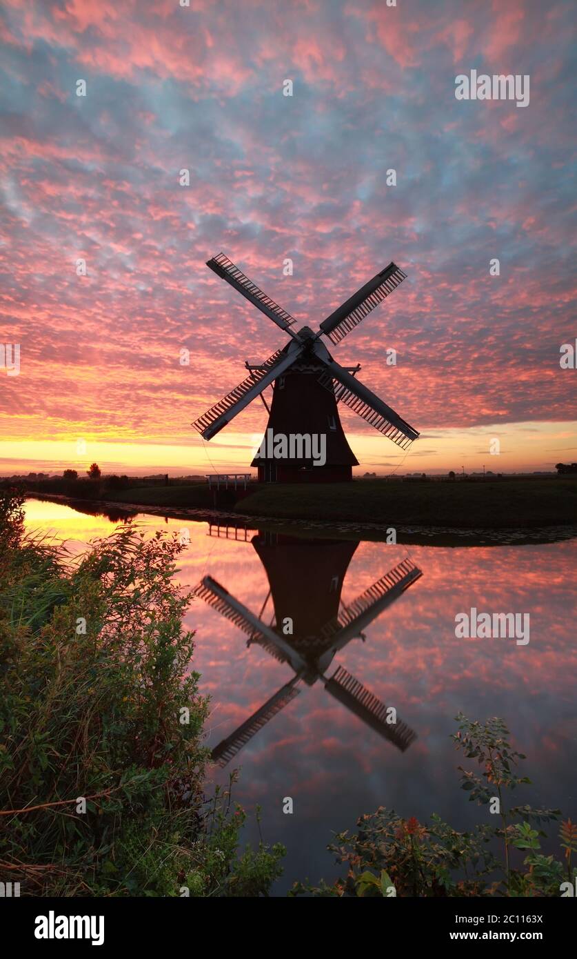 windmill and dramatic sunrise sky reflected in river Stock Photo - Alamy