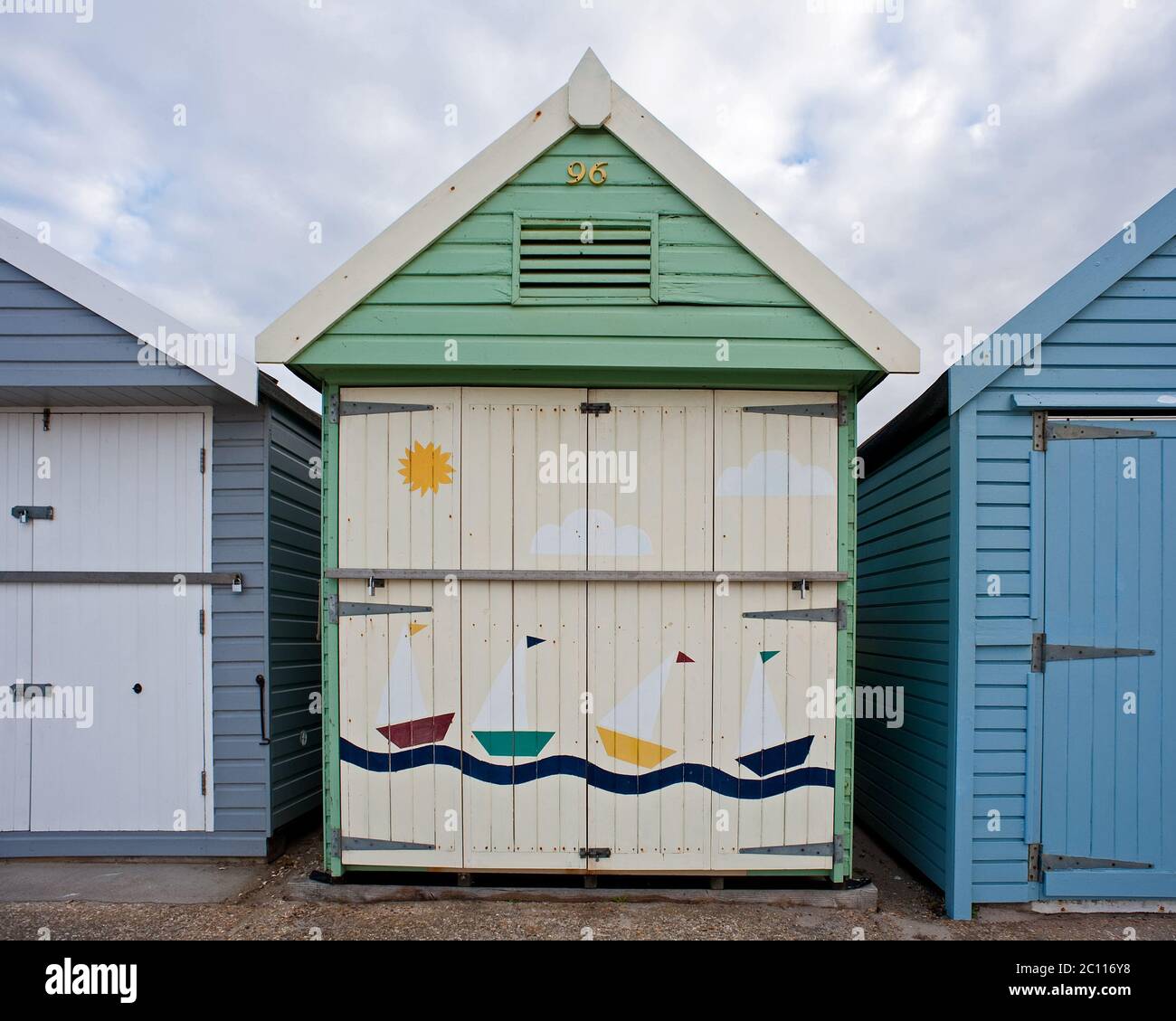 colourful beach hut painted with a sailing scene in pastel colours ...