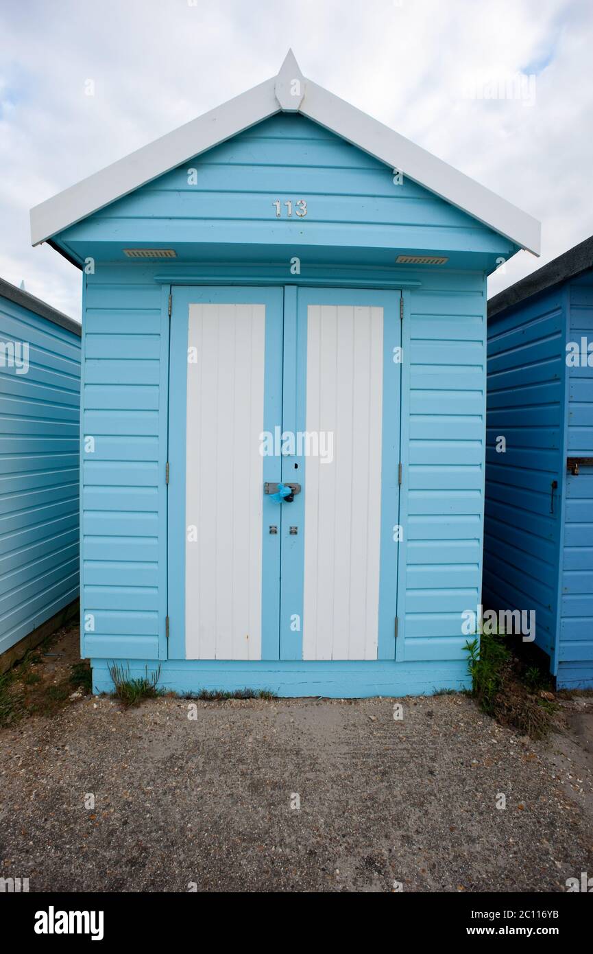 beach hut by the sea painted in light blue and white Stock Photo - Alamy