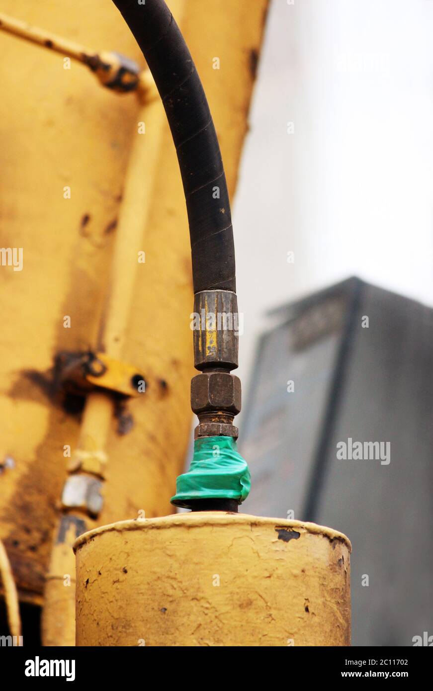 hose from the hydraulic system of the crane, crocked green tape Stock ...