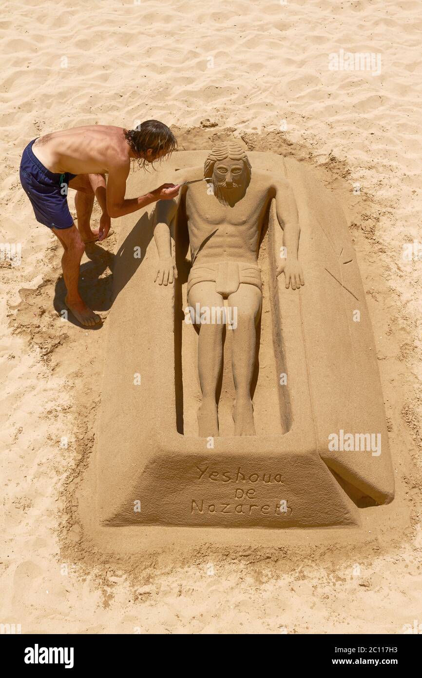 Young Man Working on Sand Sculpture of Jesus in Cadiz, Spain Stock ...