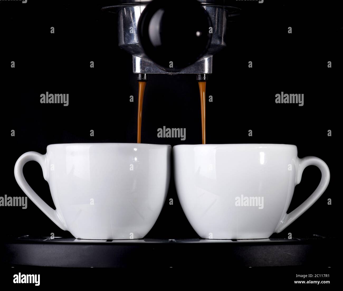 Espresso pouring from coffee machine Stock Photo - Alamy