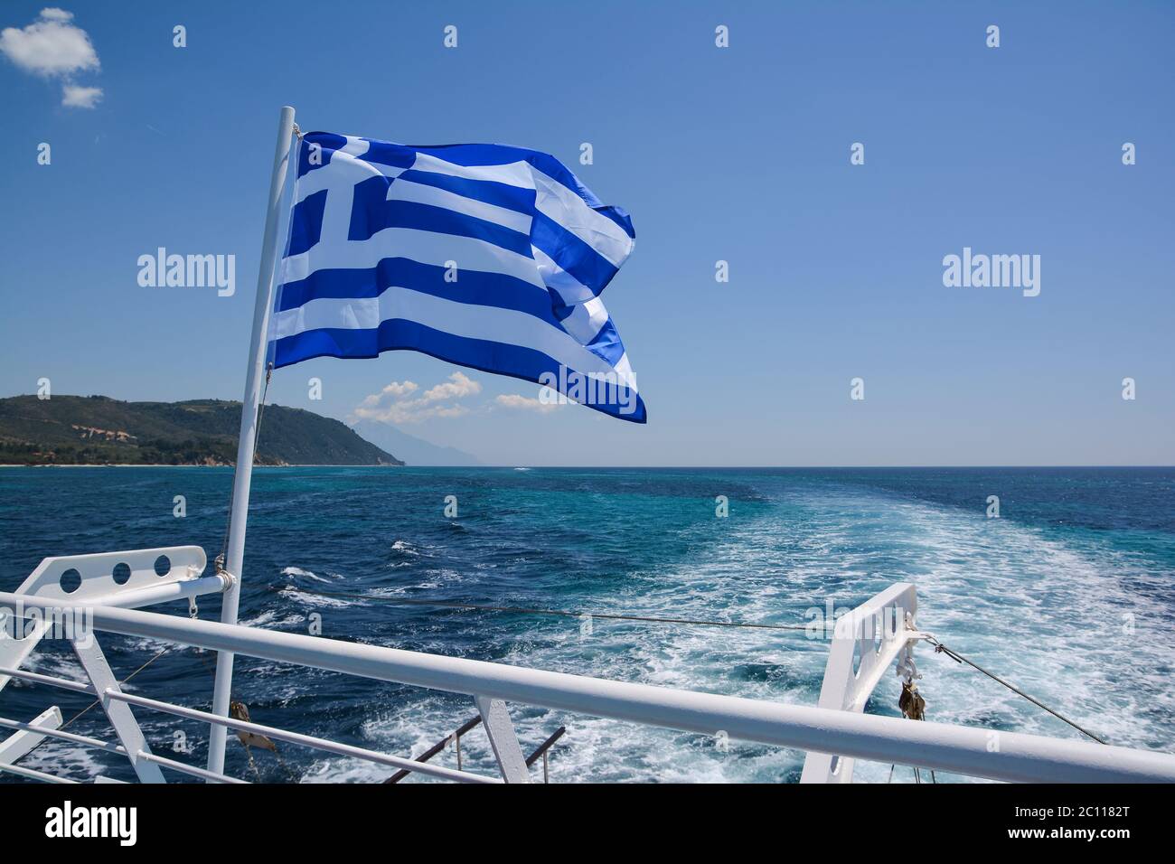 Greek flag on board a cruise boat travelling along Mount Athos ...