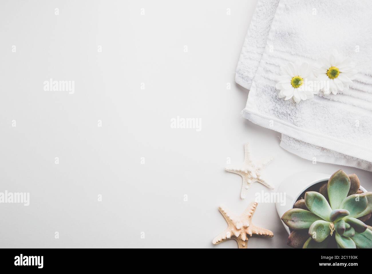 Spa wellness flat lay. Spa towel with flowers, candle and seastares ...