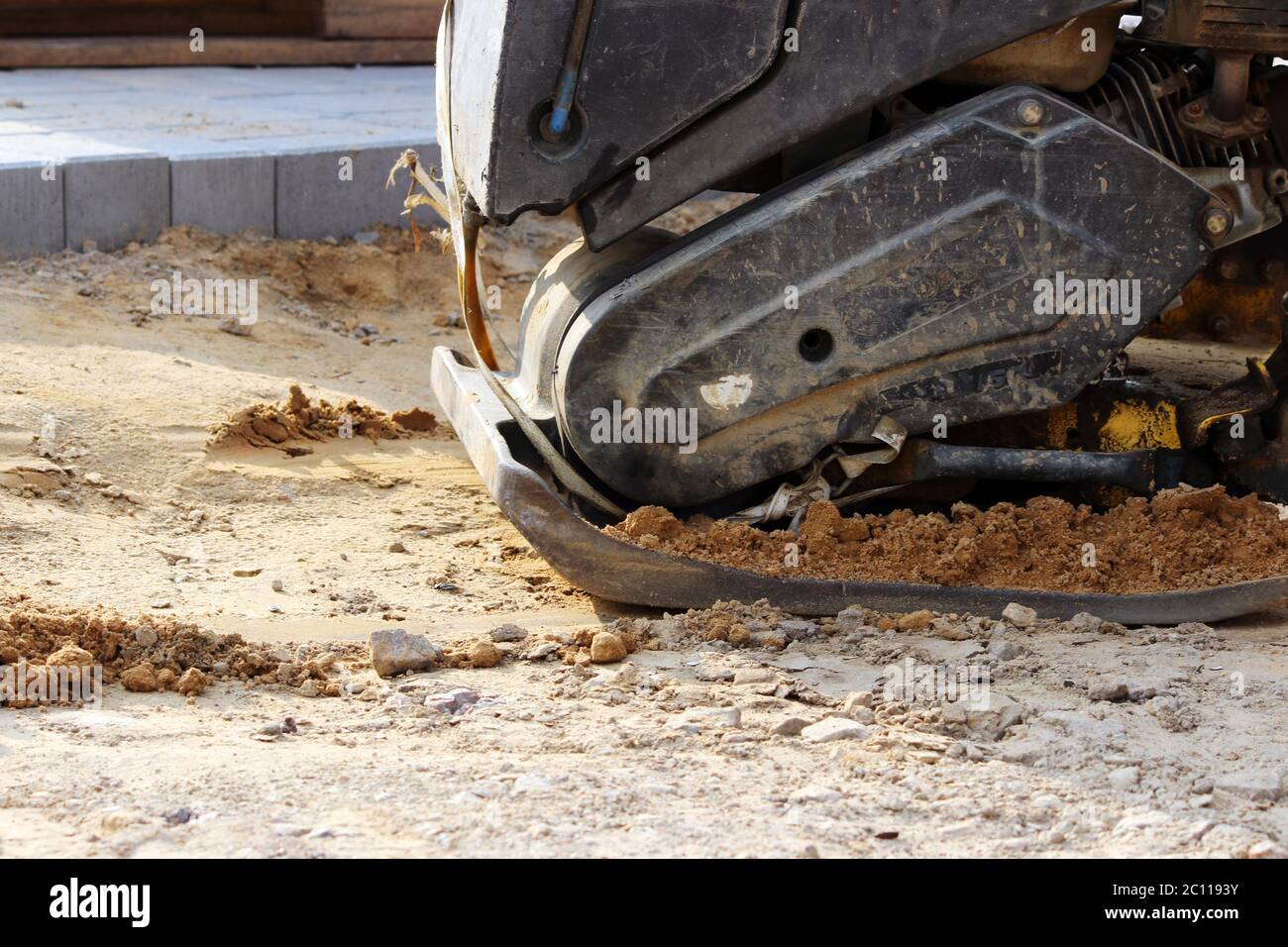laying paving slabs on city square, repairing sidewalk. platform ...