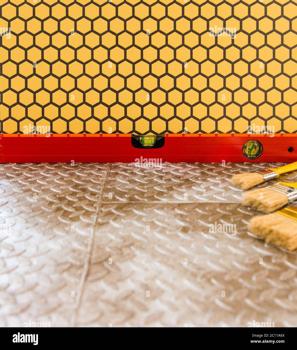 paint brushes and level measuring tool over metallic surface at ...