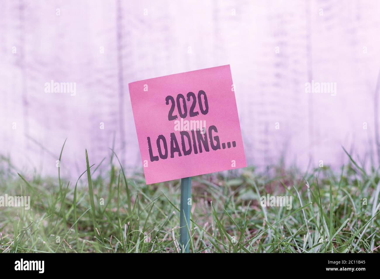 Writing note showing 2020 Loading.... Business concept for a year ...