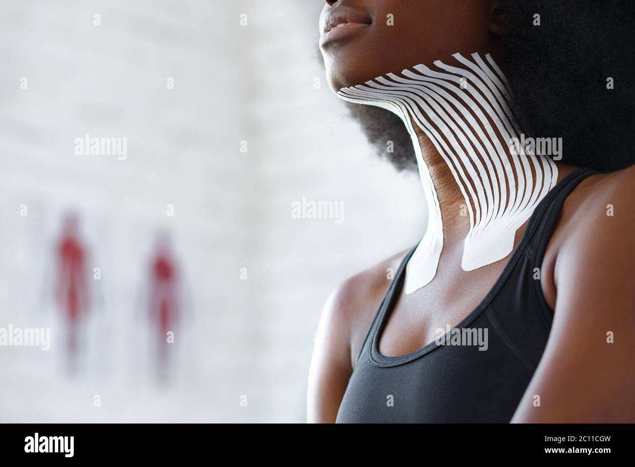 Kinesiology taping. Physiotherapist applying kinesiology tape to patient neck. Therapist ...