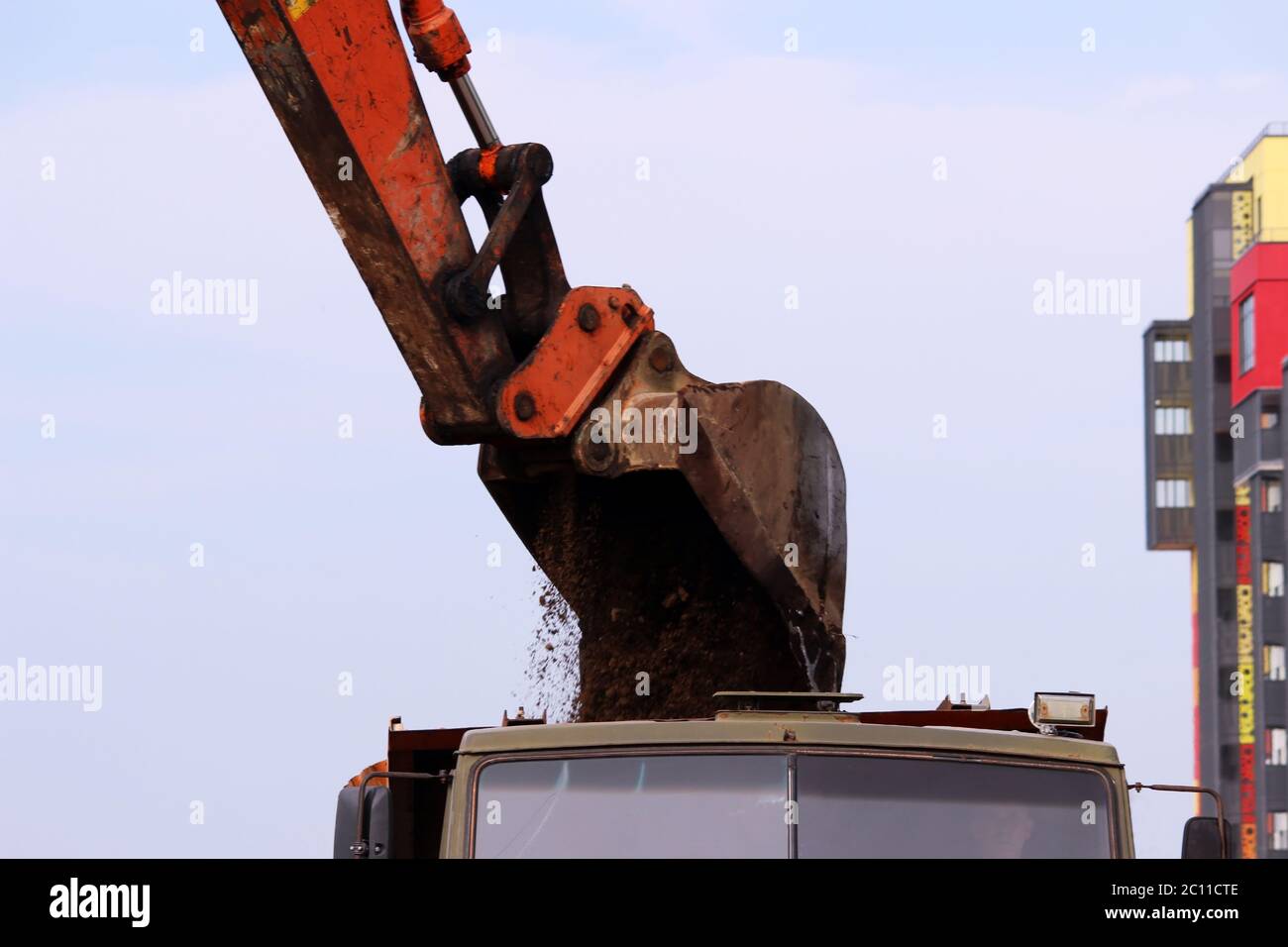 tracked excavator bucket digging peat for the preparation of land ...