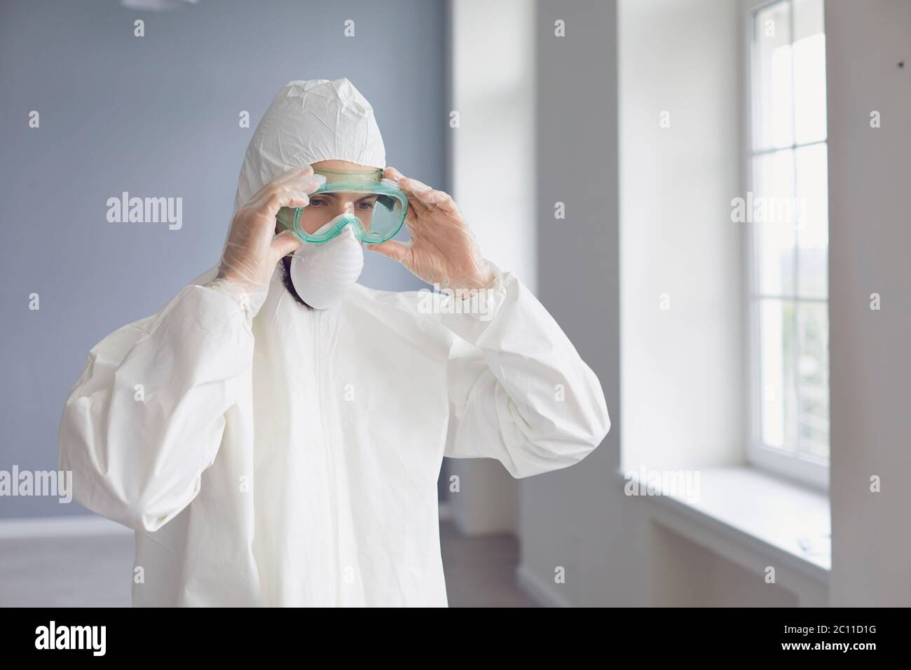 Male medicine specialist wearing PPE face mask and body protective suit ...