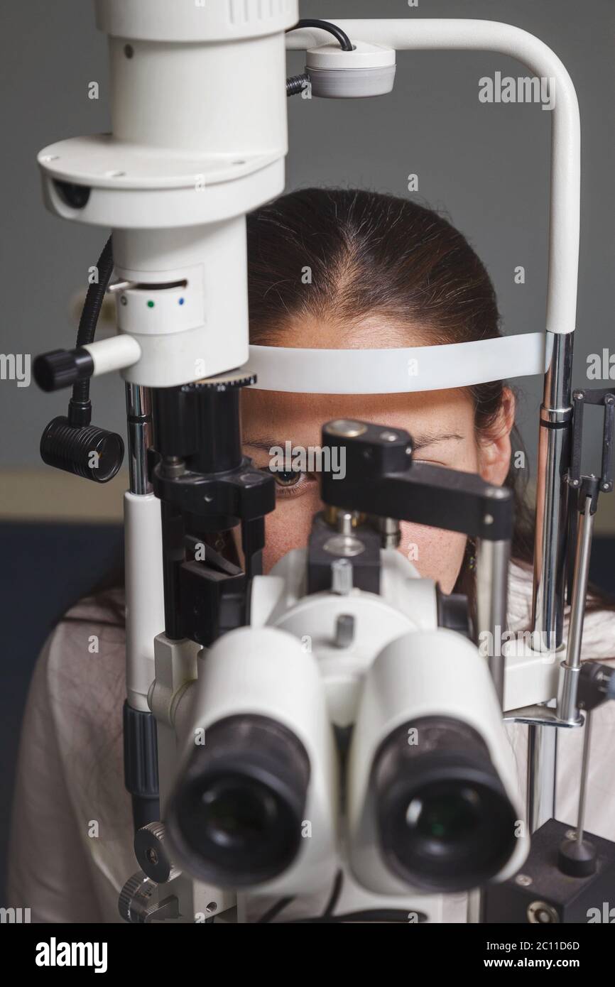 Beautiful young woman having eye test at the optometrist Stock Photo ...