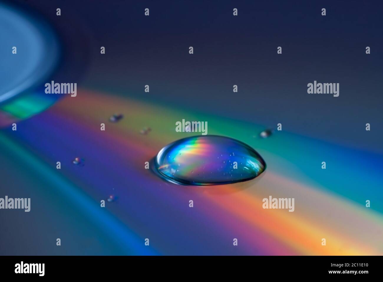 Closeup of rainbow colored reflection and water droplets on CD Stock ...
