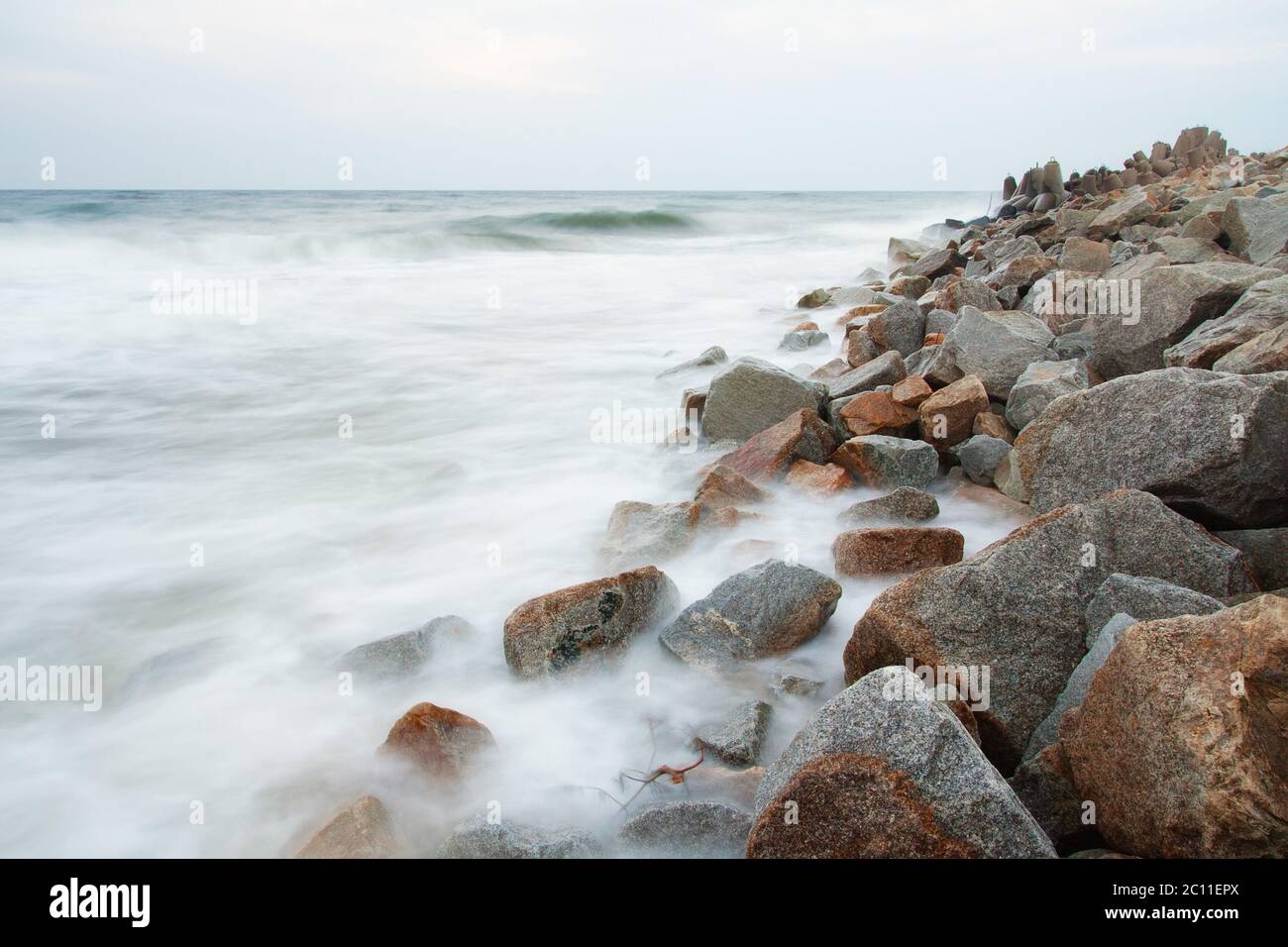 Stone breakwater photographed on long exposure Stock Photo - Alamy