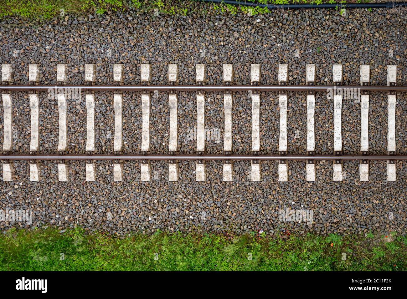 Railway tracks on a railway track bed lead through the picture Stock ...