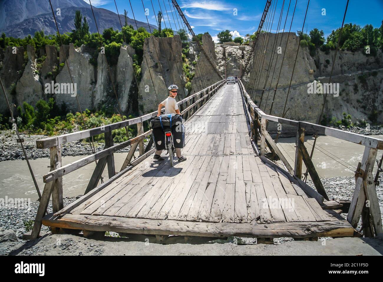 Cyclist crossing wooden bridge Stock Photo - Alamy