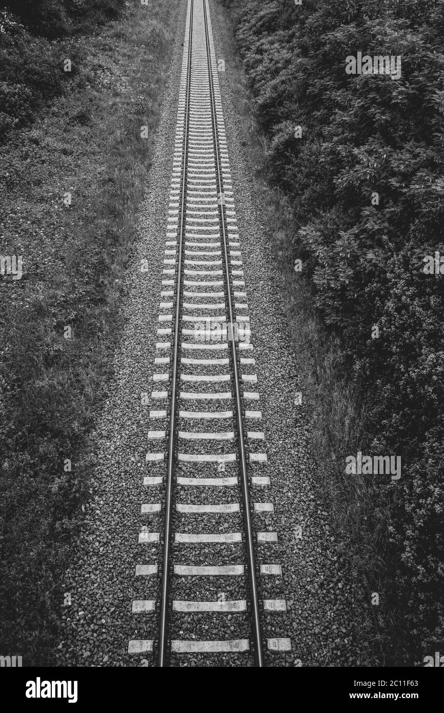 Railway tracks on a railway track bed lead through the picture Stock ...