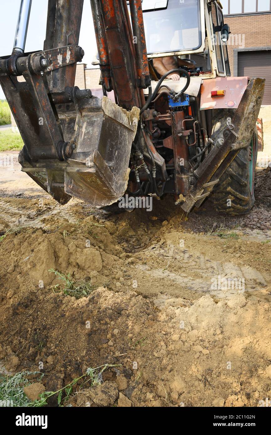 Excavator bucket digging a trench in the dirt ground Excavator bucket ...