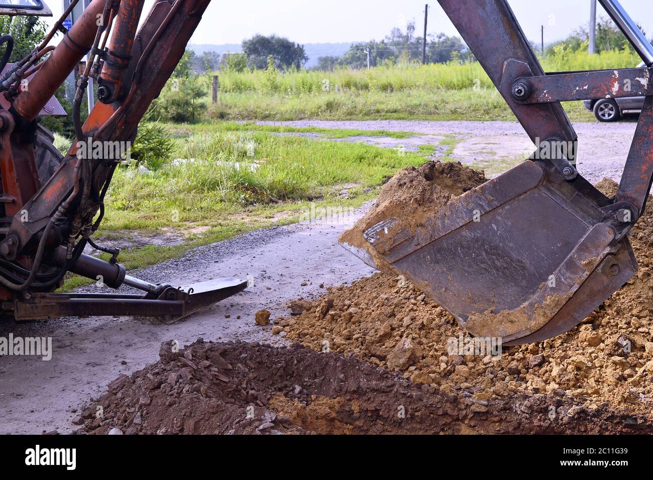 Excavator bucket digging a trench in the dirt ground Excavator bucket ...