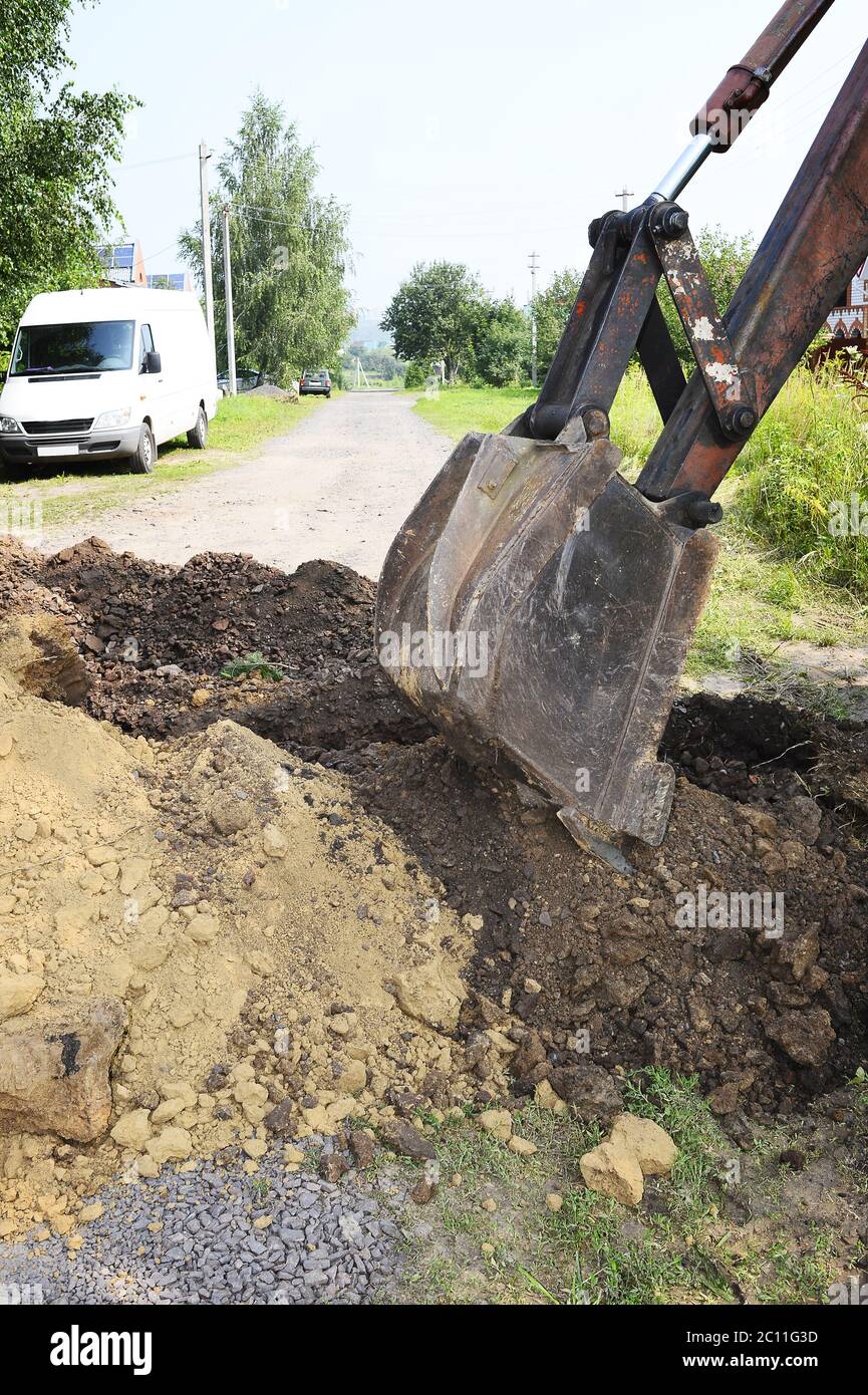 Excavator bucket digging a trench in the dirt ground Excavator bucket ...