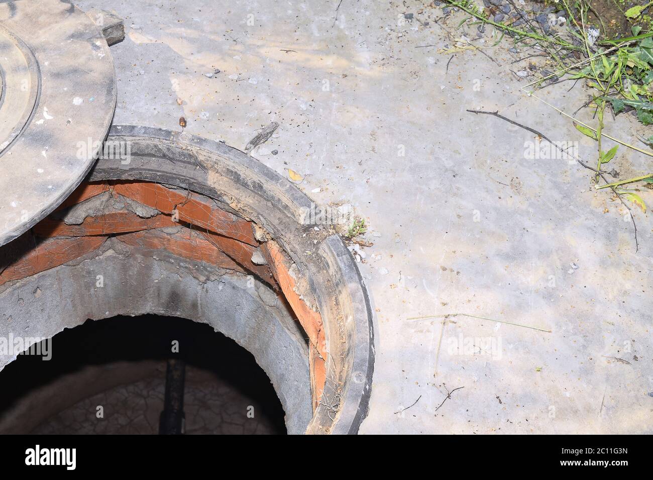 Concrete cesspit with an open hatch on the ground in the summer Stock ...