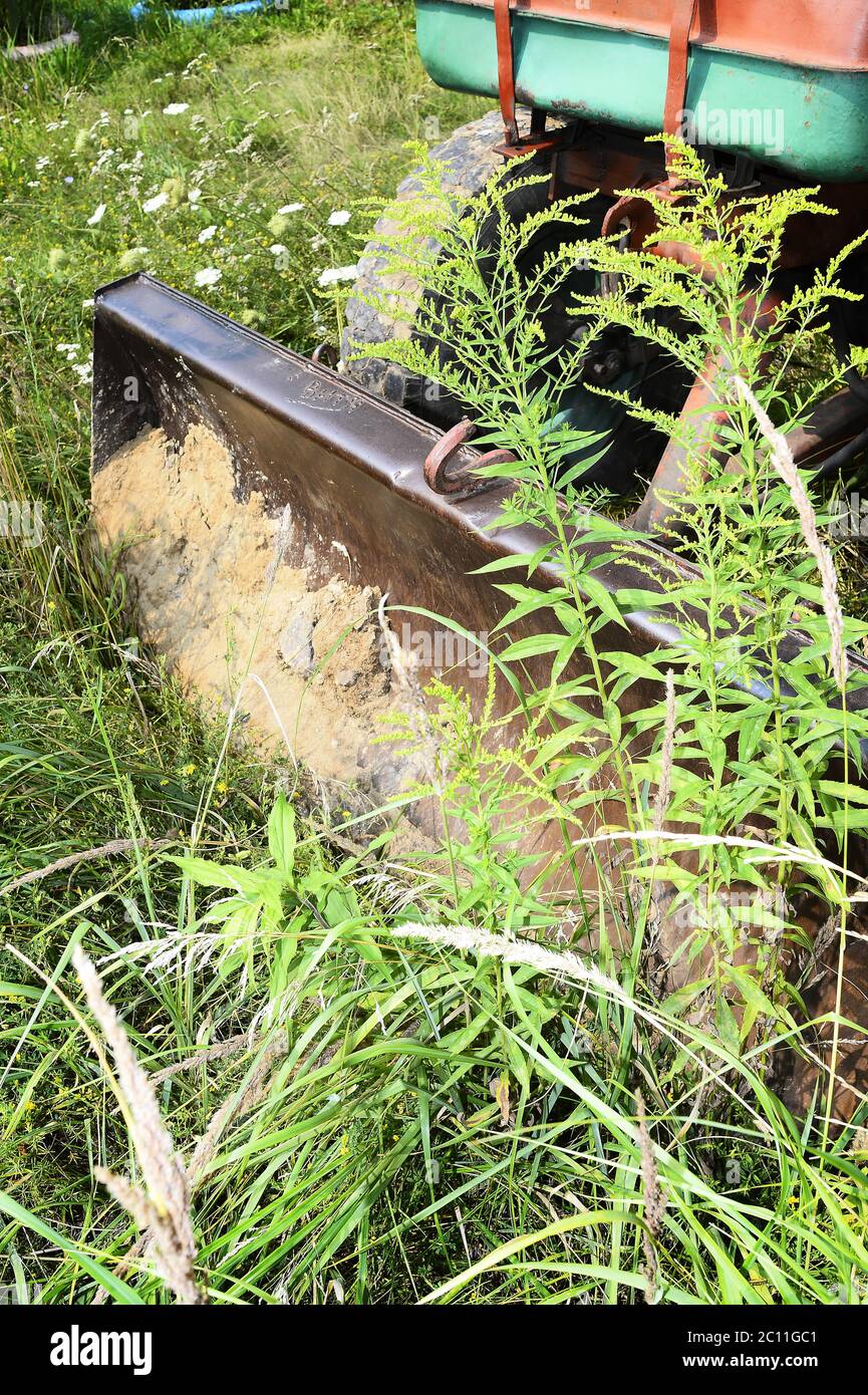 Bulldozer, destroying the plants growing on soil Bulldozer, destroying ...