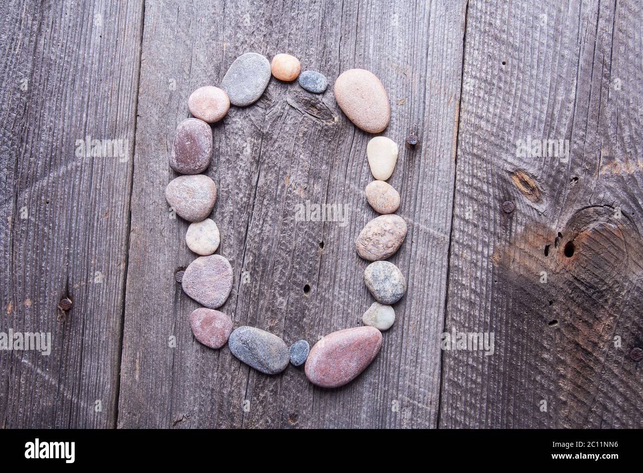 O - Letter alphabet stones laid out on the old wood Stock Photo - Alamy