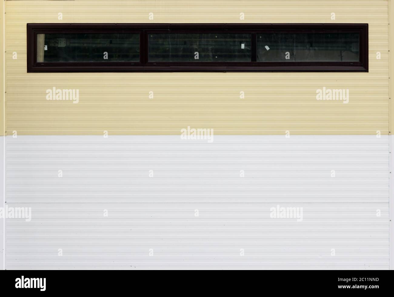 Wall tile with long horizontal window and a seams, painted in white ...