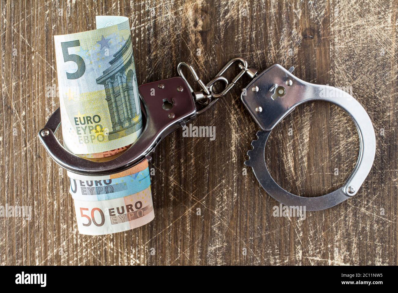 Money handcuffs hi-res stock photography and images - Alamy