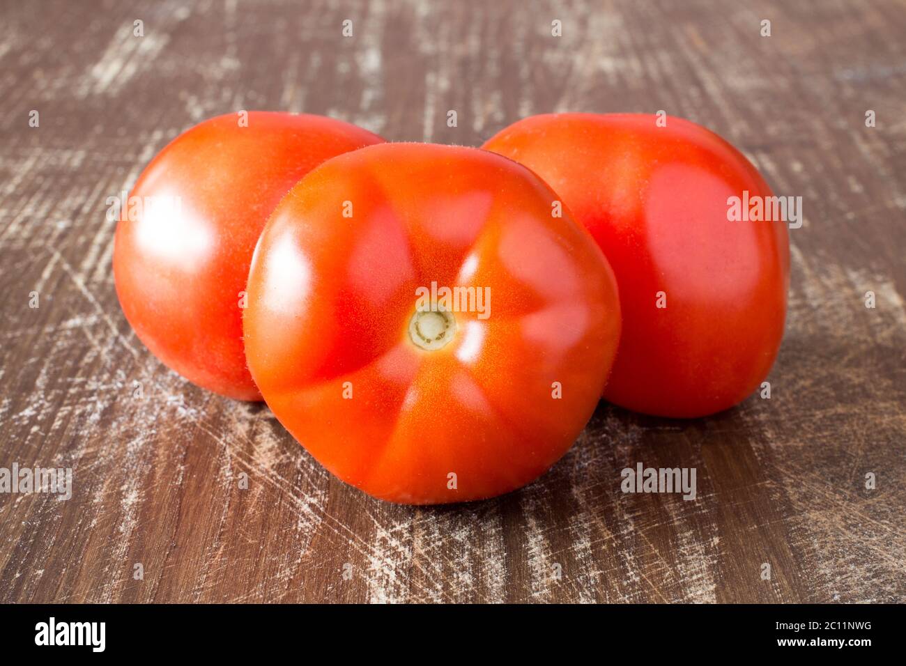 Three red tomatoes Stock Photo - Alamy