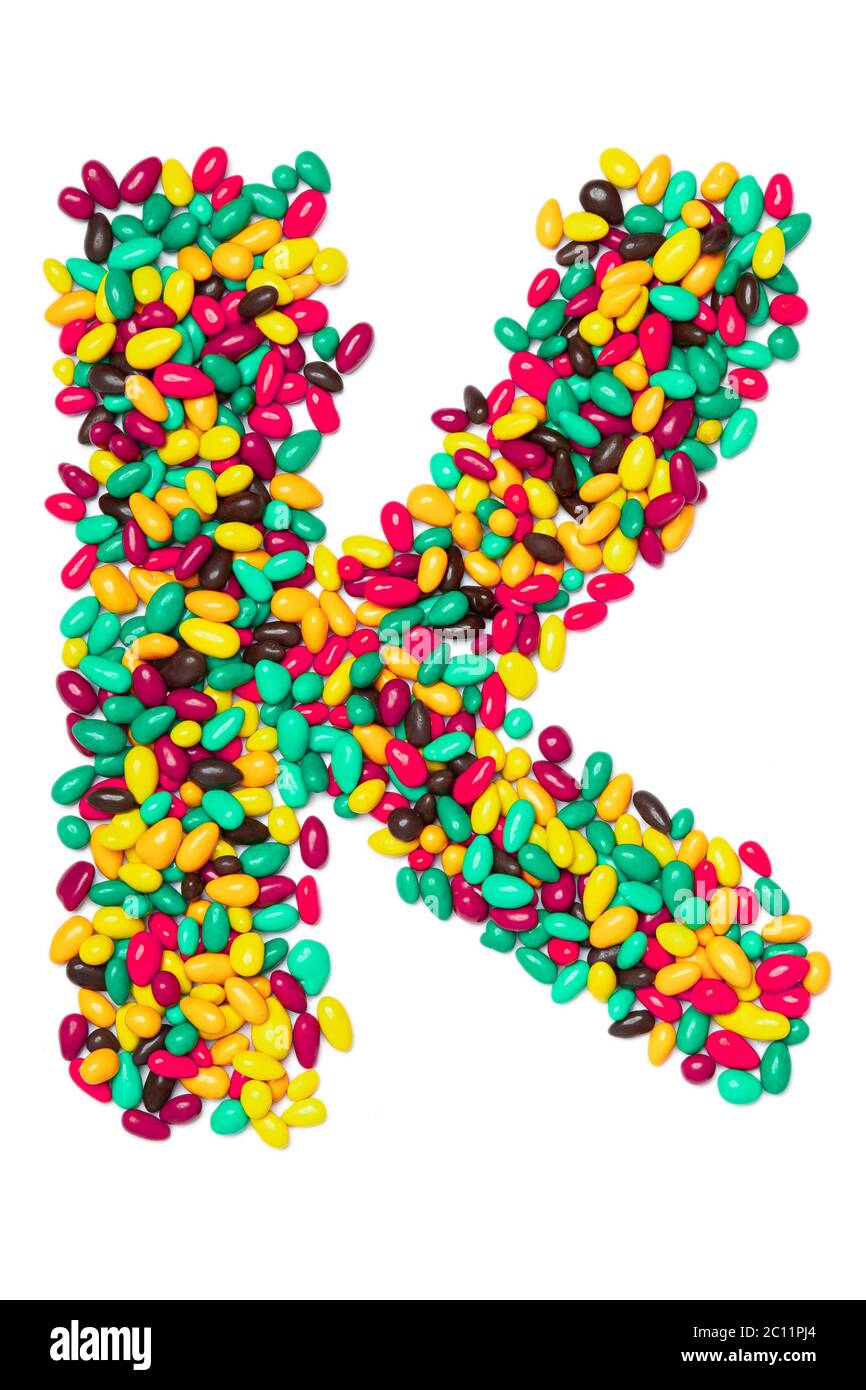 Letter K of the English alphabet from multicolored round chocolates on ...