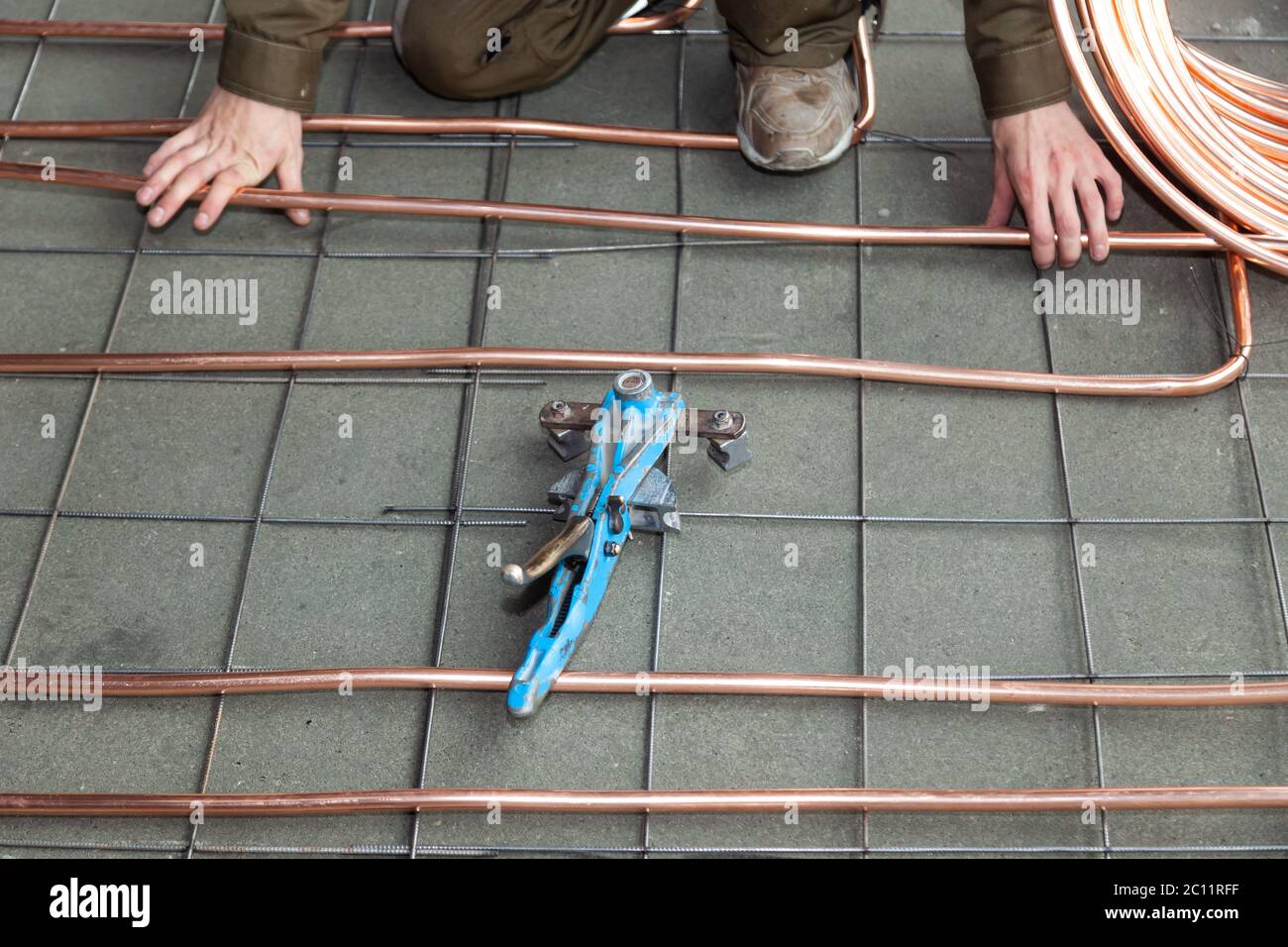 male hands bends copper pipes by pipe bender Stock Photo - Alamy