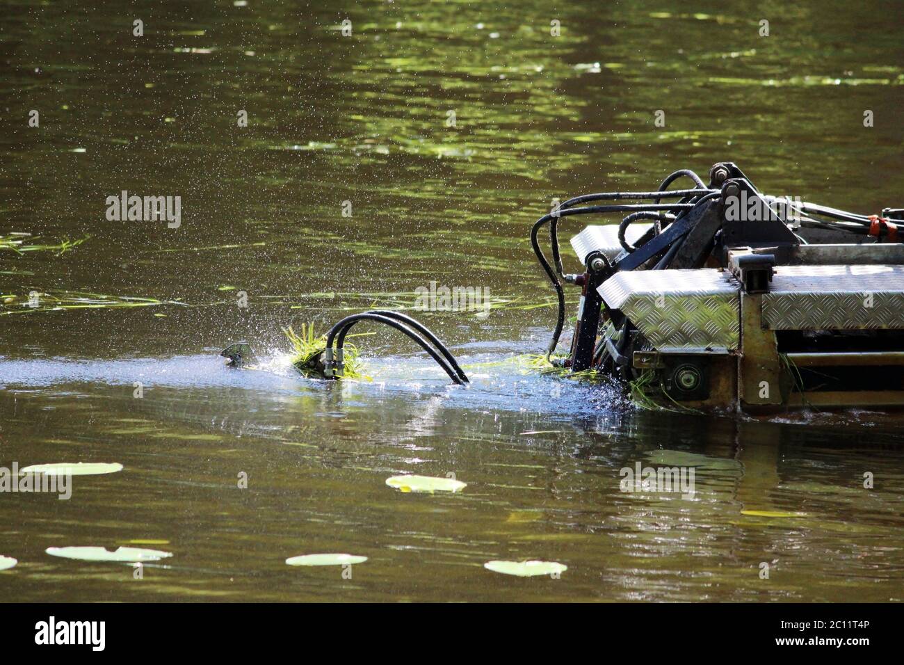 mini dredger is clearing lake algae summer day Stock Photo - Alamy