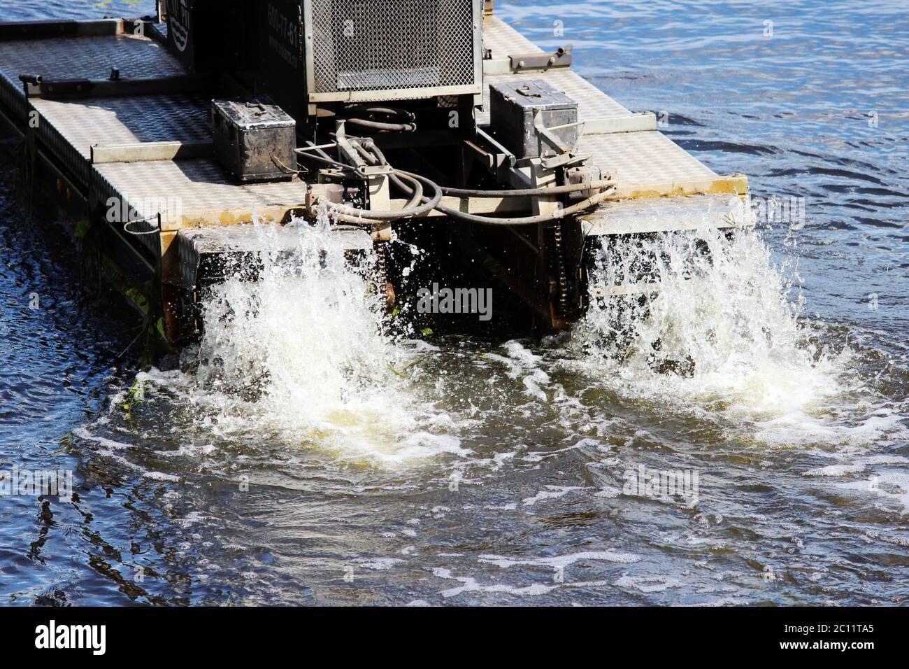 mini dredger is clearing lake algae summer day Stock Photo - Alamy