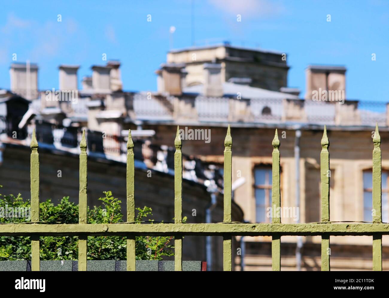 green metal grille enclosing the patio next to the old historical ...