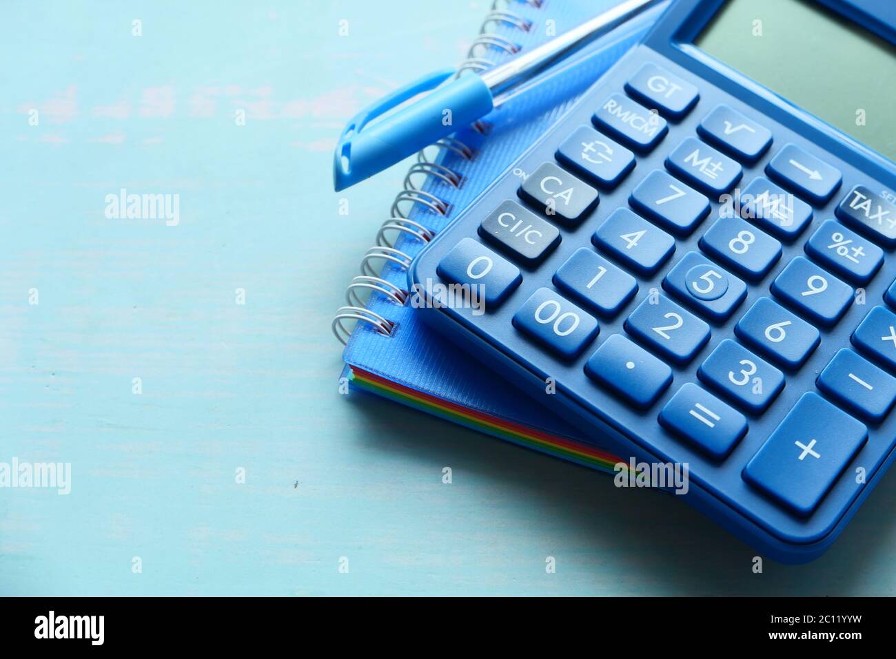 Close up of calculator, pen and notepad on desk Stock Photo - Alamy