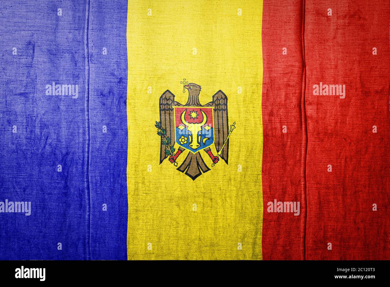 National flag of Moldova depicting in paint colors on old textile. Flag ...
