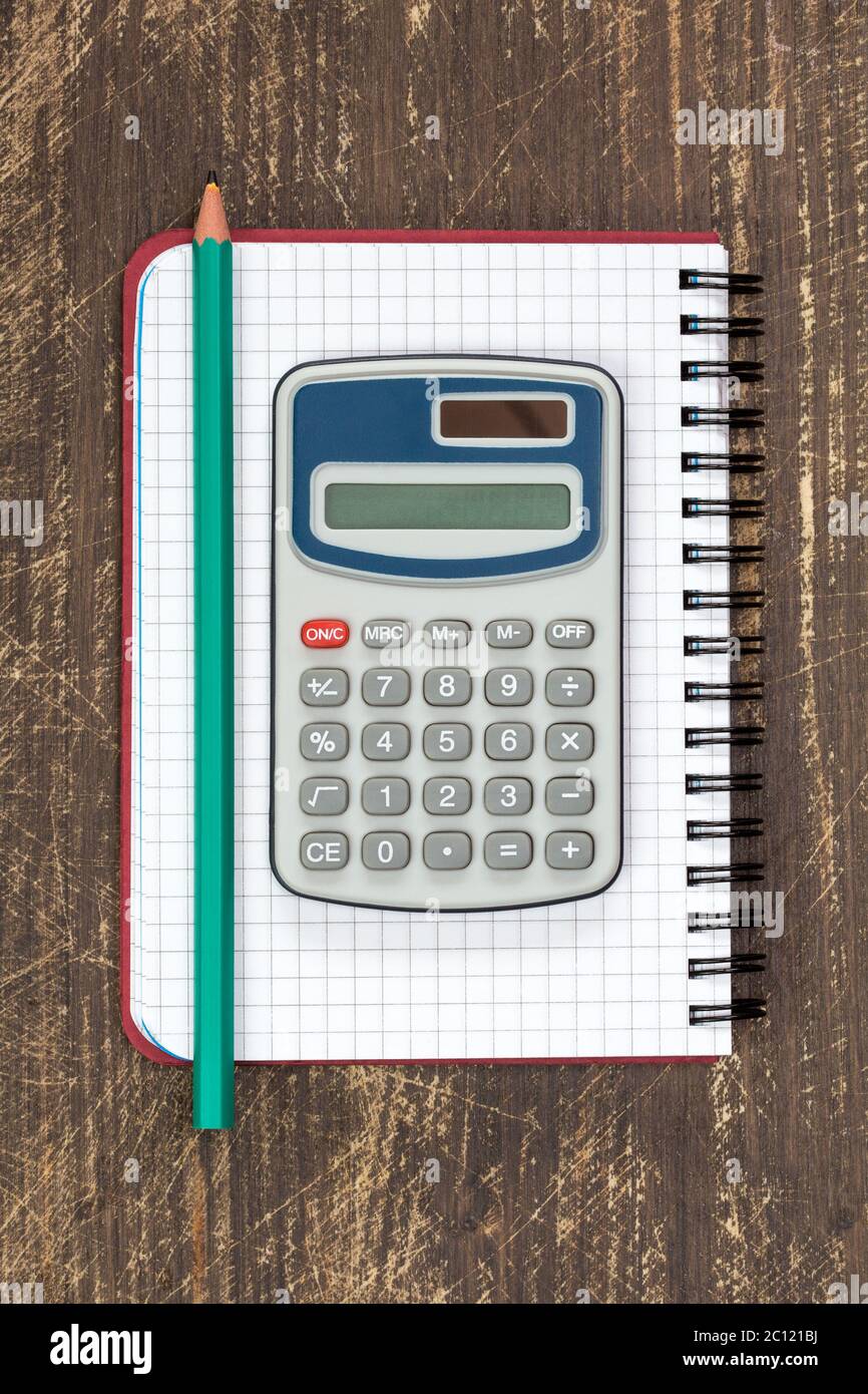 Digital calculator and spiral notebook with pencil Stock Photo - Alamy
