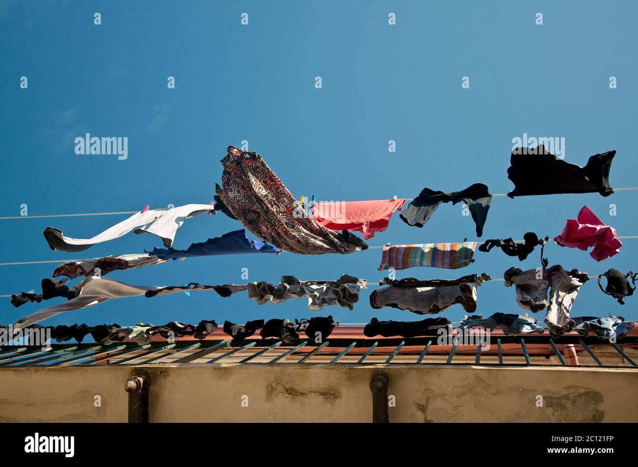 beautiful clothes hanging to dry on the balcony Stock Photo - Alamy