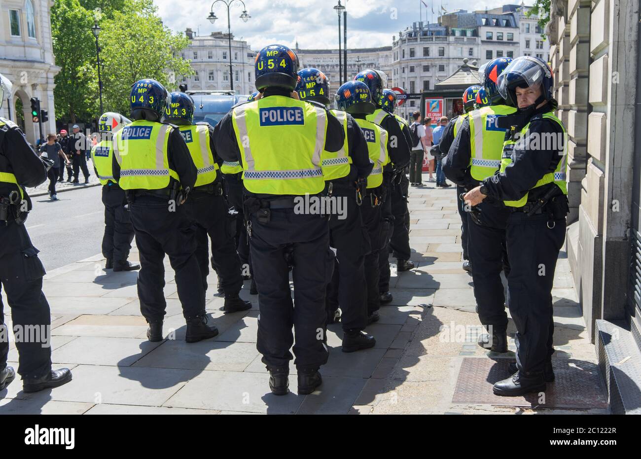 Riot police in full protection gear getting ready to go into a far ...