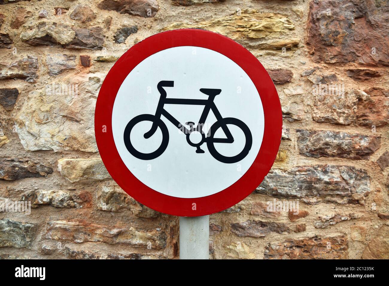 Circular red, white and black cycling sign (no pedal bike permitted to be ridden) with icon of ...
