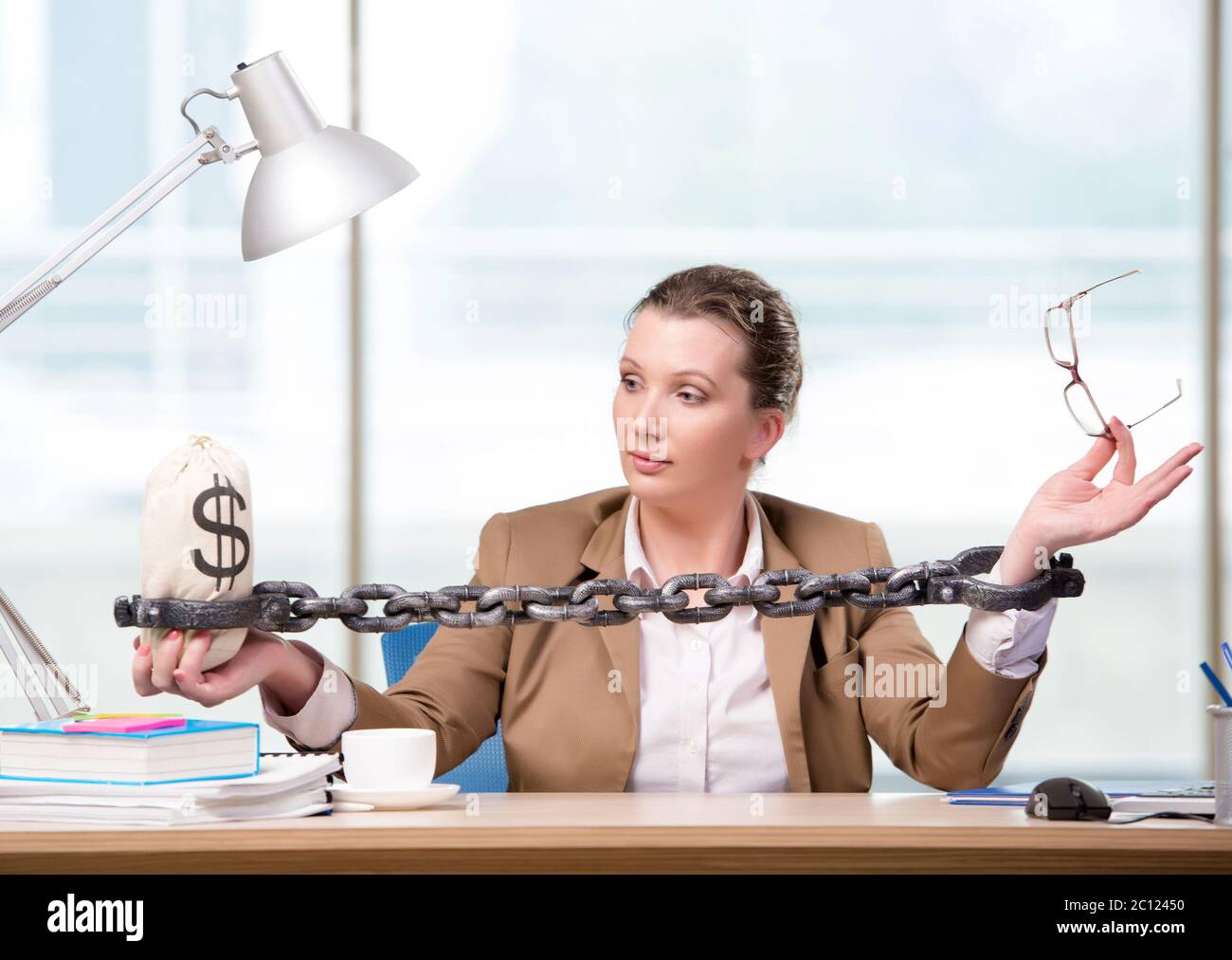 Woman chained working desk hi-res stock photography and images - Alamy