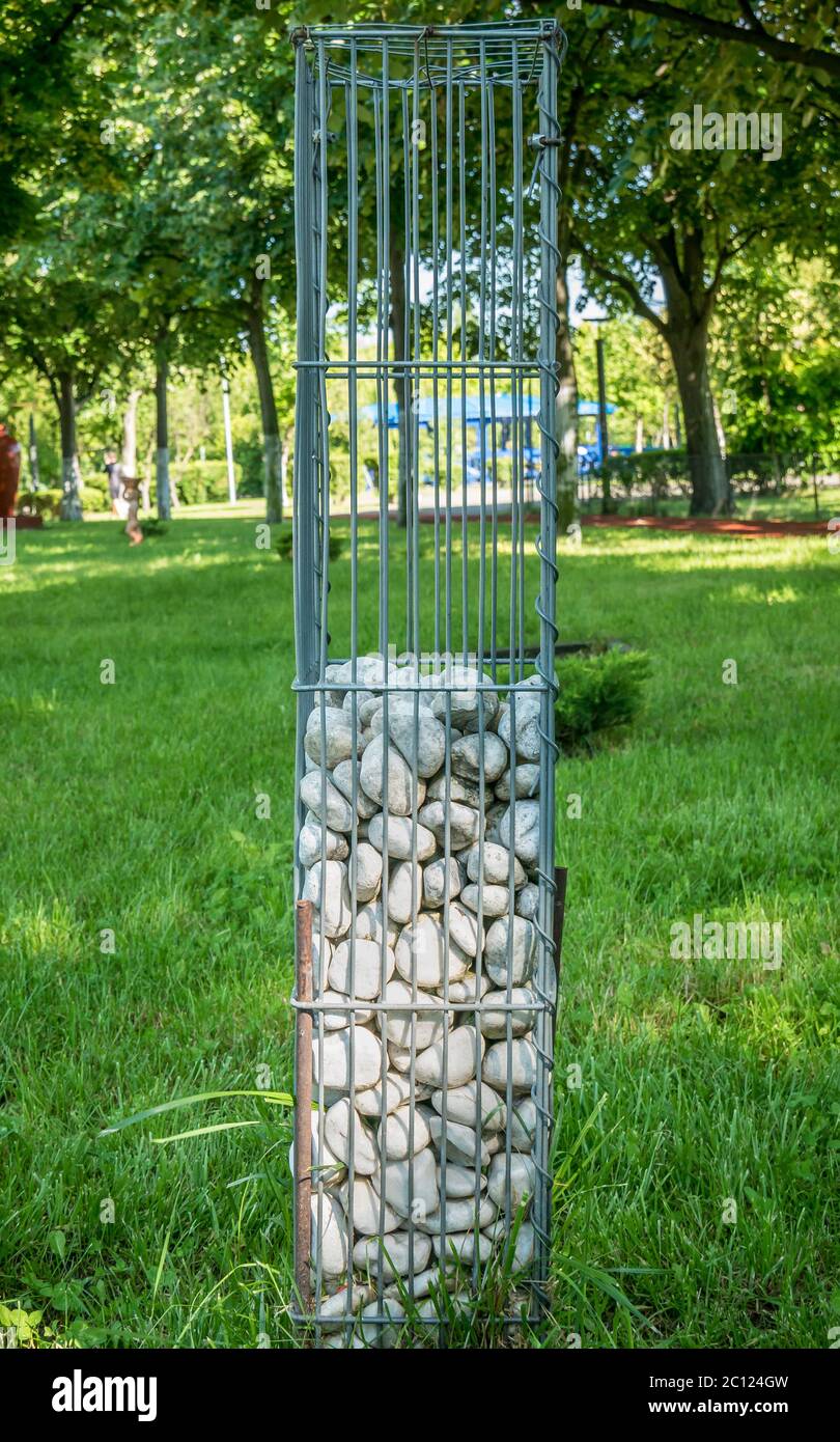 Stones in a metal cage as a decoration for a garden or park Stock Photo ...