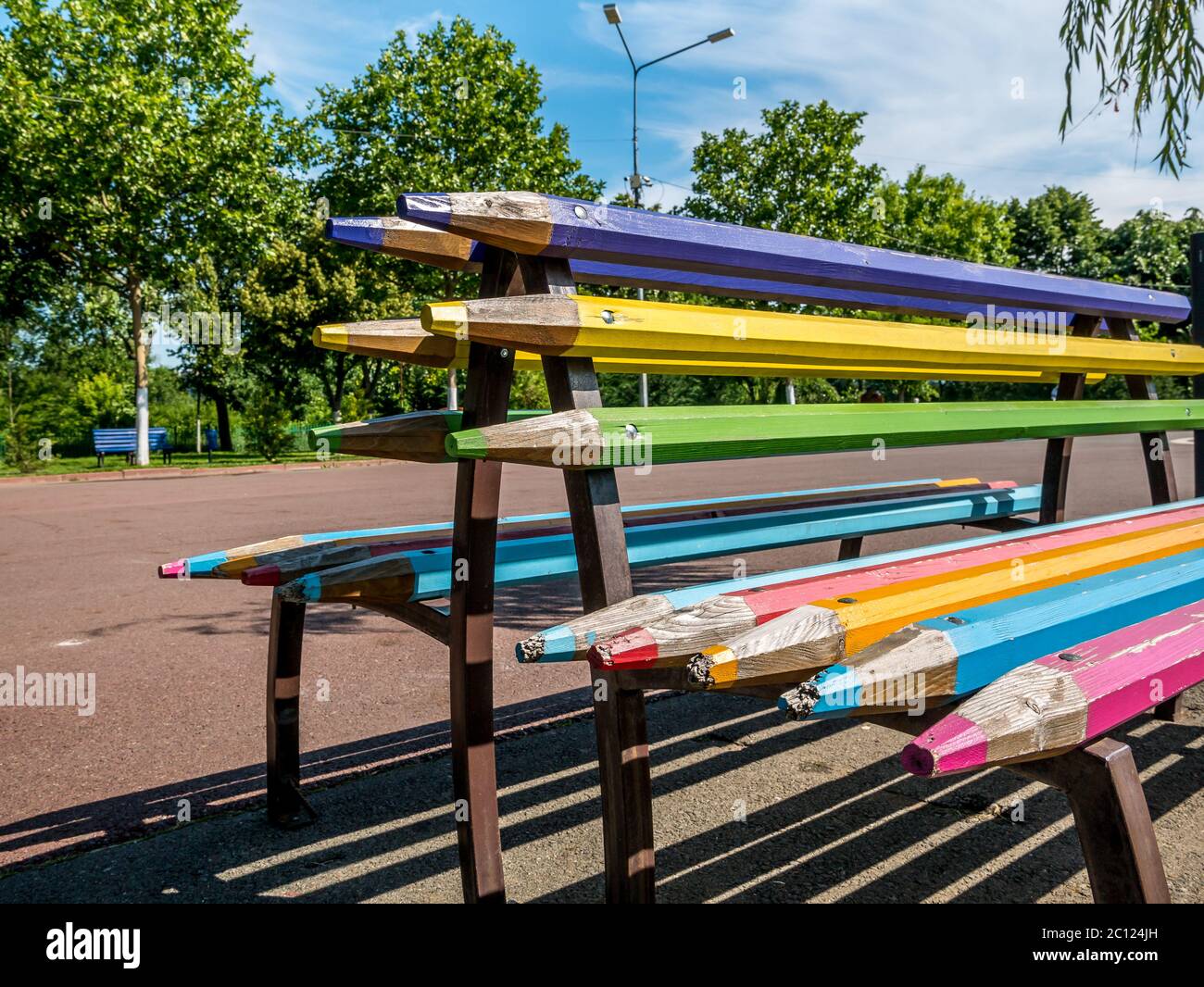 A bench made of big wooden colored pencils Stock Photo - Alamy