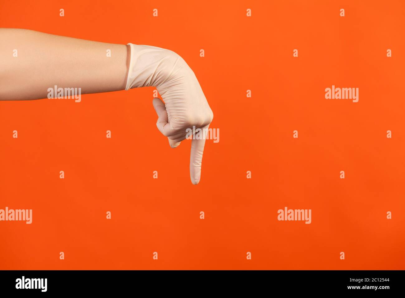 Profile side view closeup of human hand in white surgical gloves ...