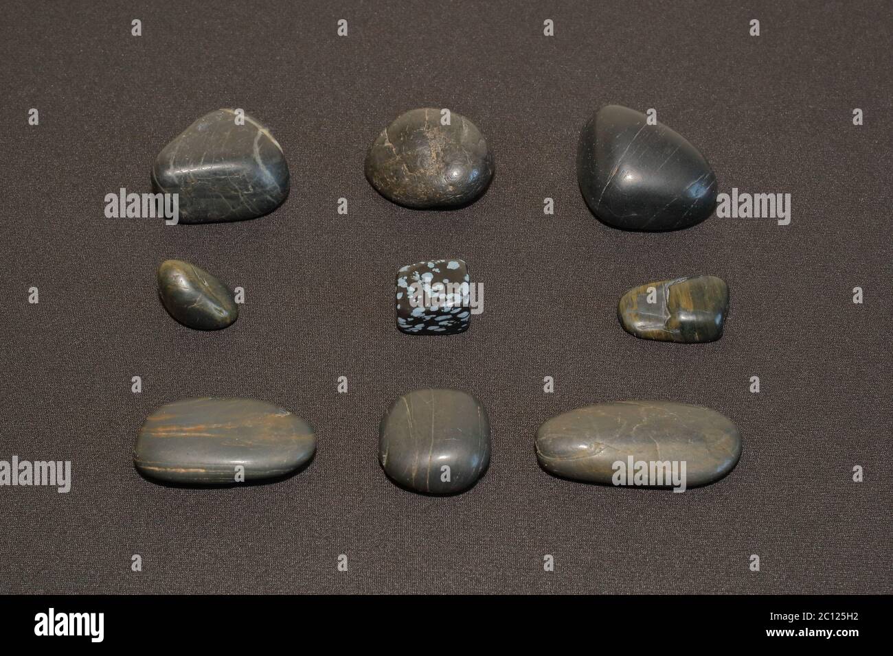 A group of stones laid out in a 3 x 3 grid pattern Stock Photo - Alamy