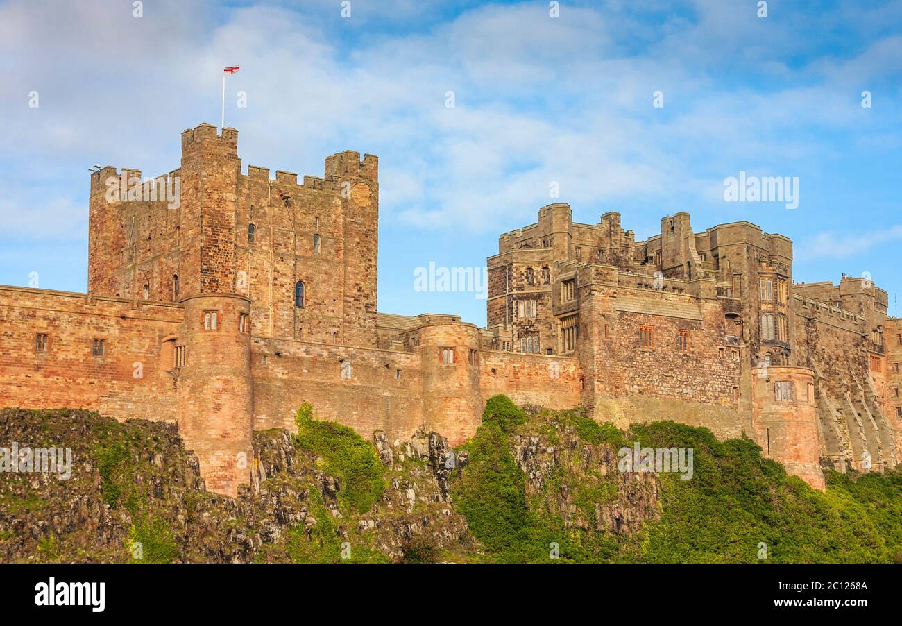 The square keep and defensive walls of Bamburgh Castle, England Stock ...