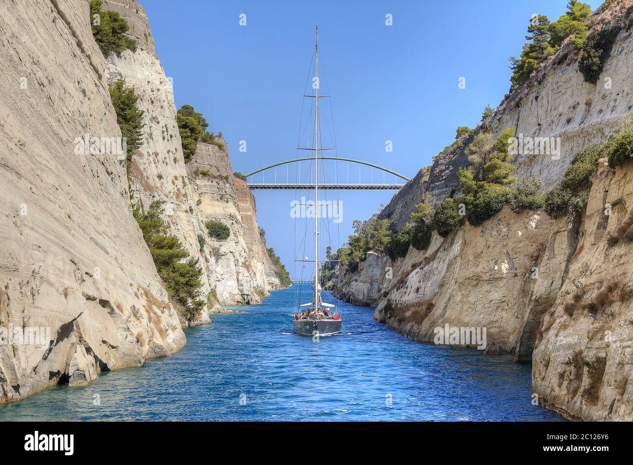 Corinth Canal. Isolated. Sailboat entering through the narrow Isthmus ...